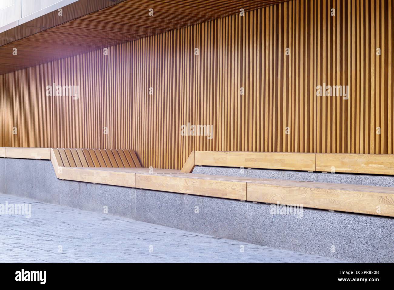 Empty modern wooden benches without people on a sunny day, public ...