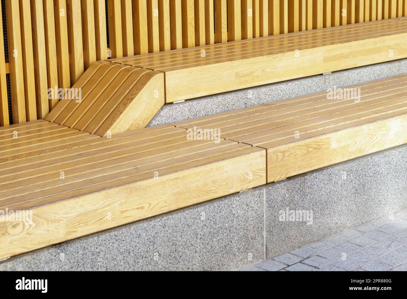Empty modern wooden benches without people on a sunny day, public ...
