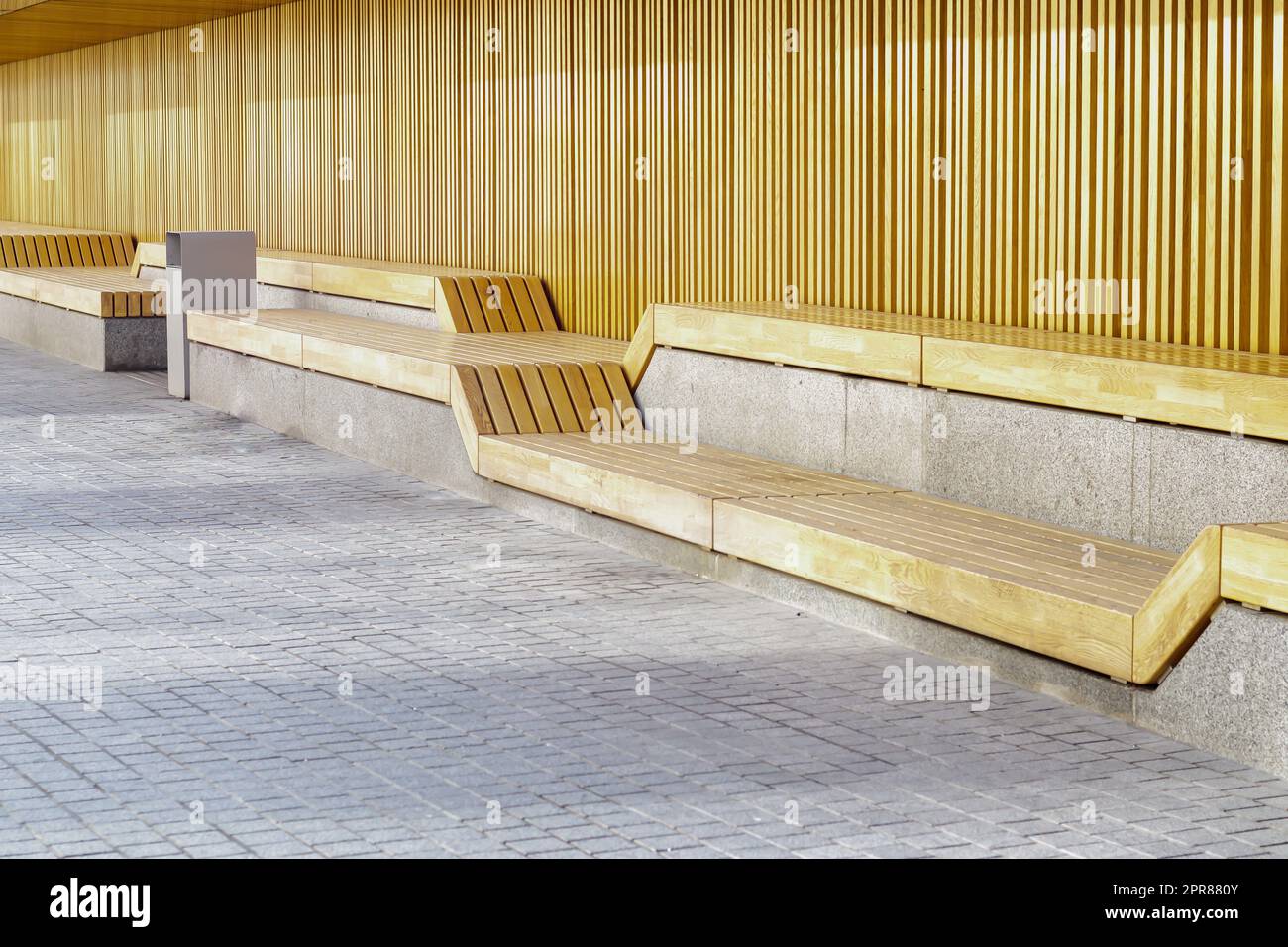 Empty modern wooden benches without people on a sunny day, public ...