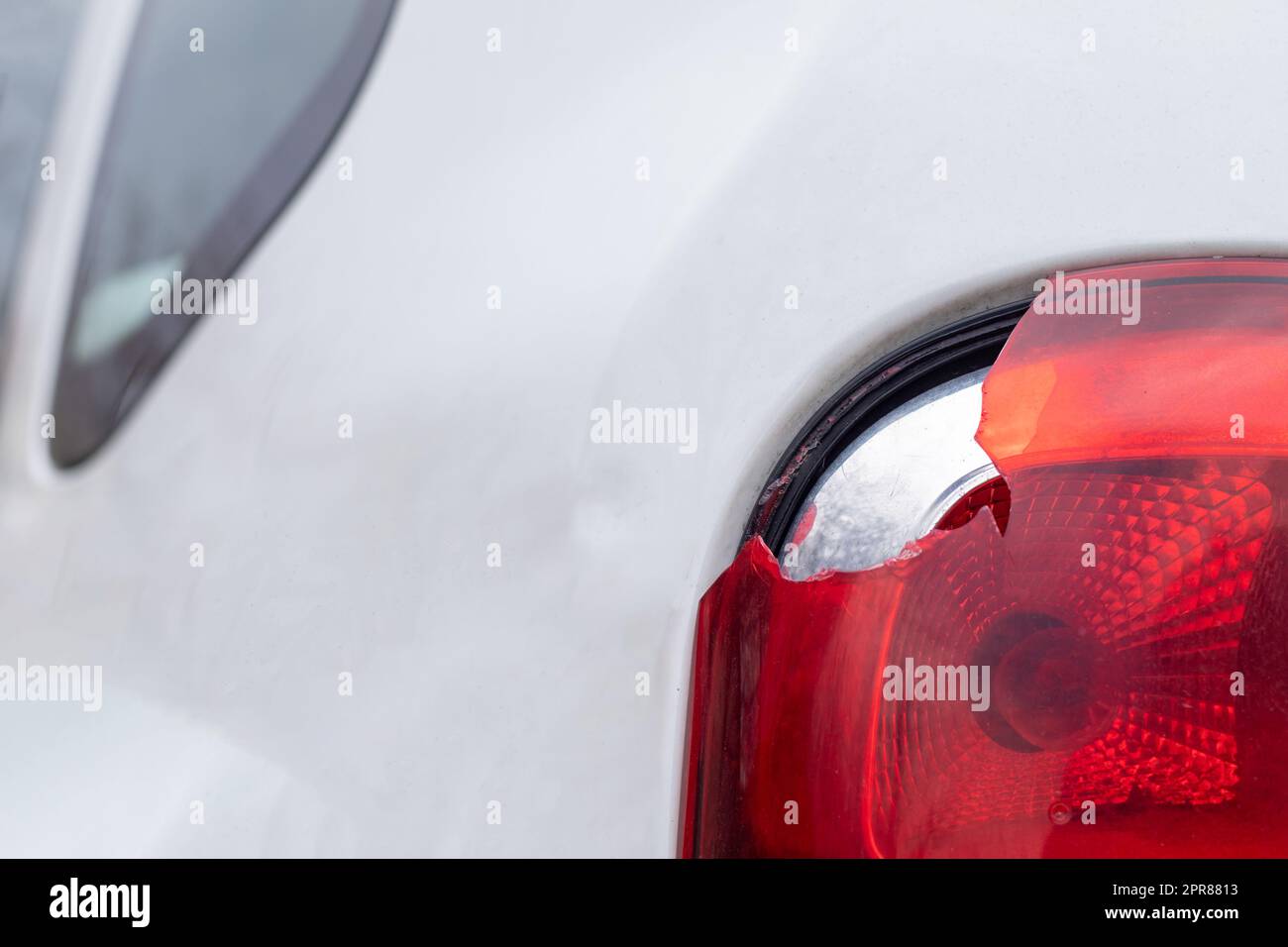 The rear left lamp of a white car is broken. The taillight of the car ...