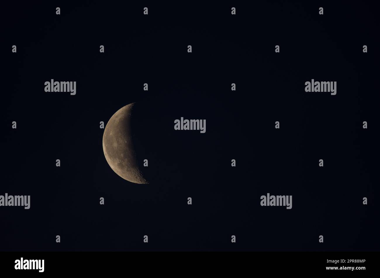 Last quarter of the moon half-covered by the clouds Stock Photo - Alamy