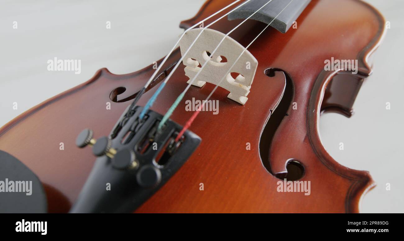Violin string and bridge close up Stock Photo - Alamy