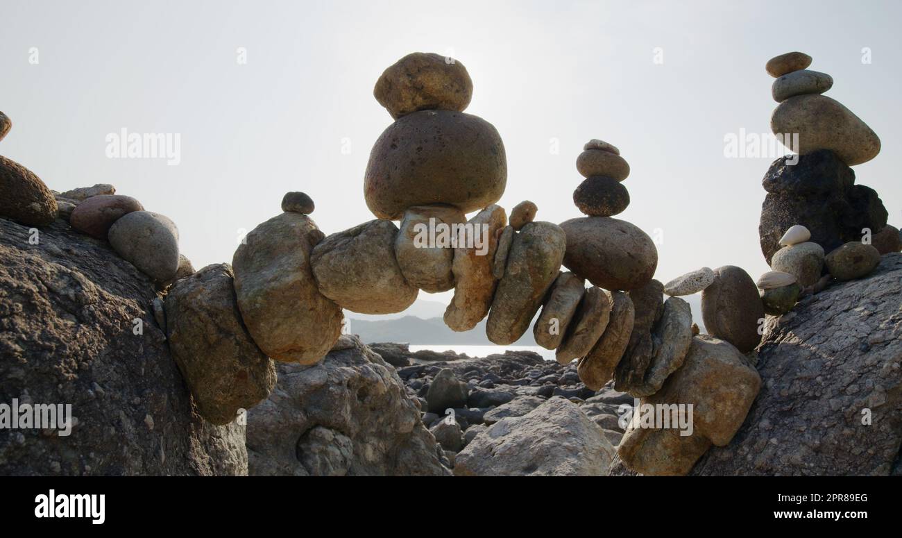 Arch of pebbles in balancing on the sea coast Stock Photo - Alamy