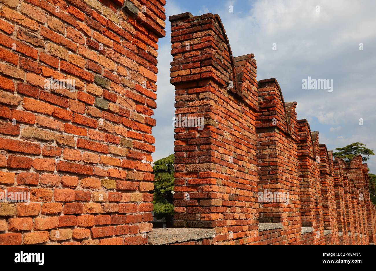 Ancient Battlements with crenellations on the city wall made with red ...
