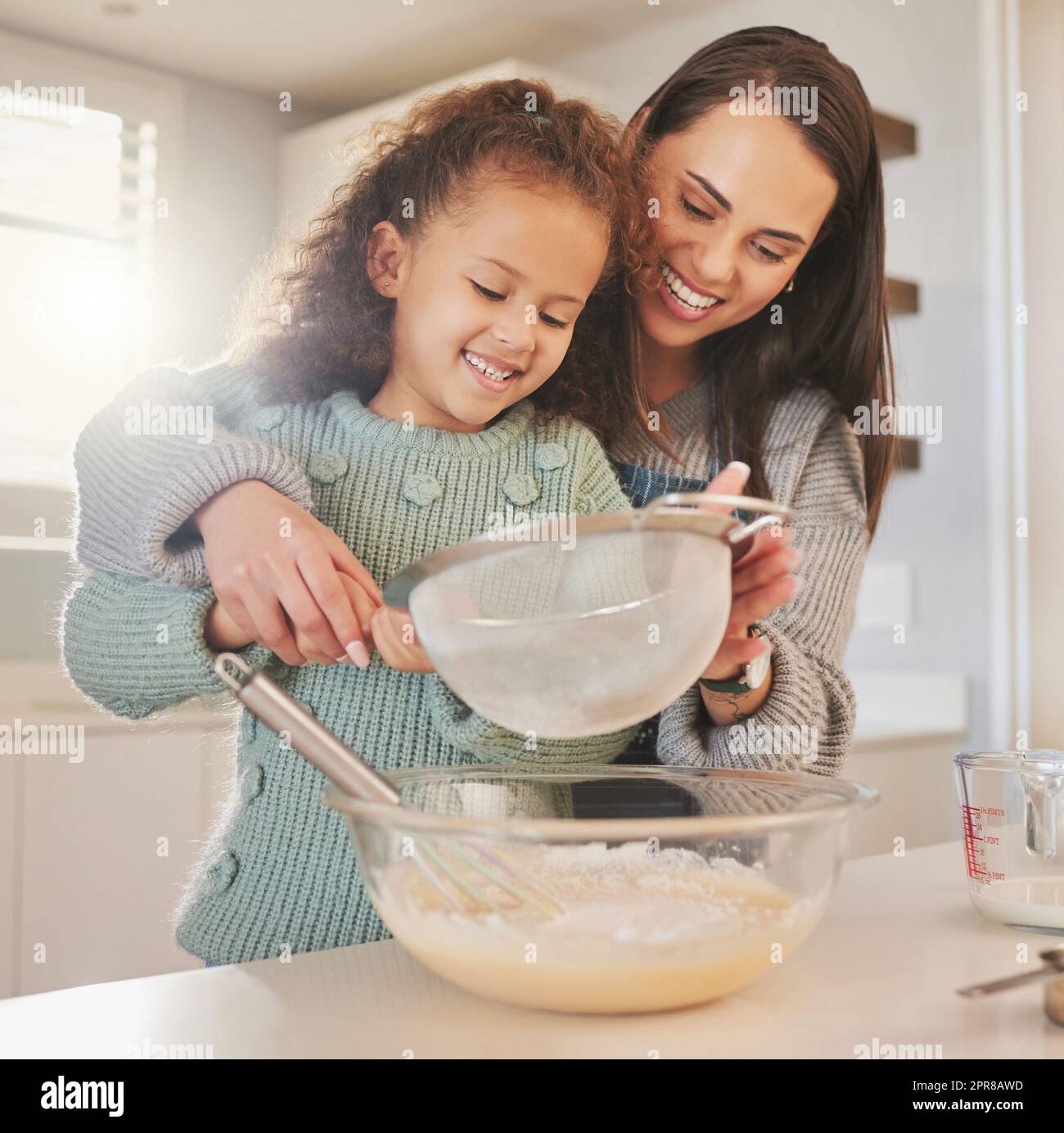 This is the secret to a light and fluffy cake. Shot of a mom baking ...