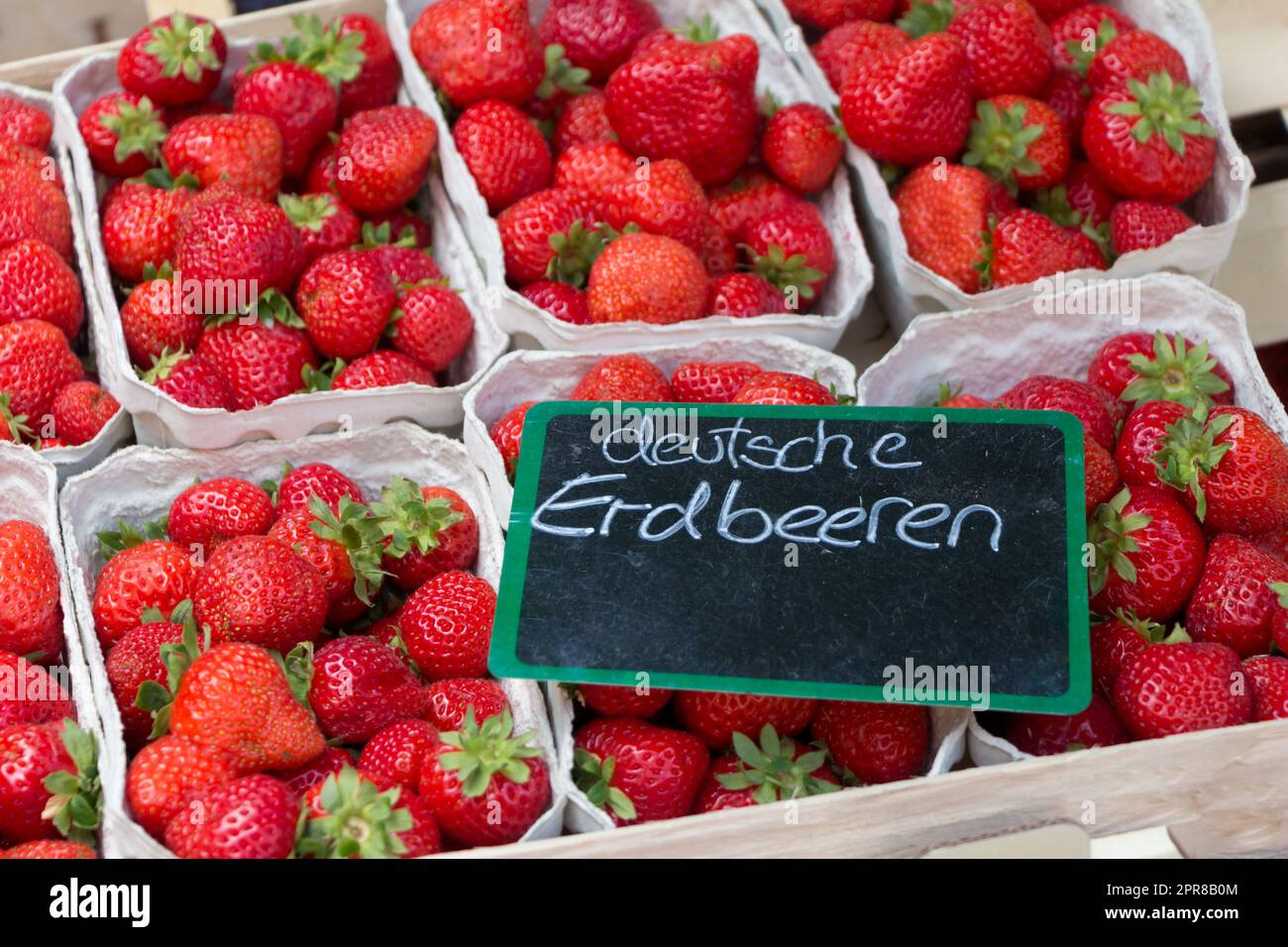 German red strawberries market baskets with black label sign Stock ...