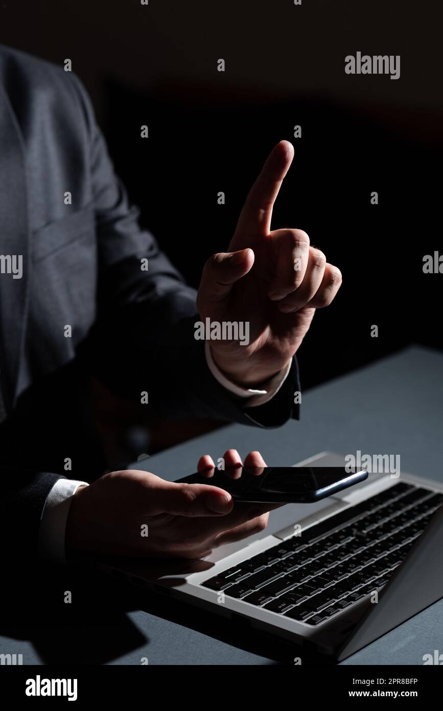 Businessman Holding Mobile Phone In Hand And Pointing With One Finger ...