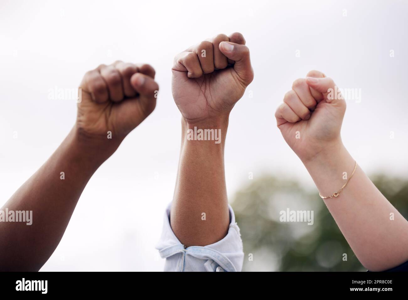 Take a stand, make a change. a group of students raising their fists in ...