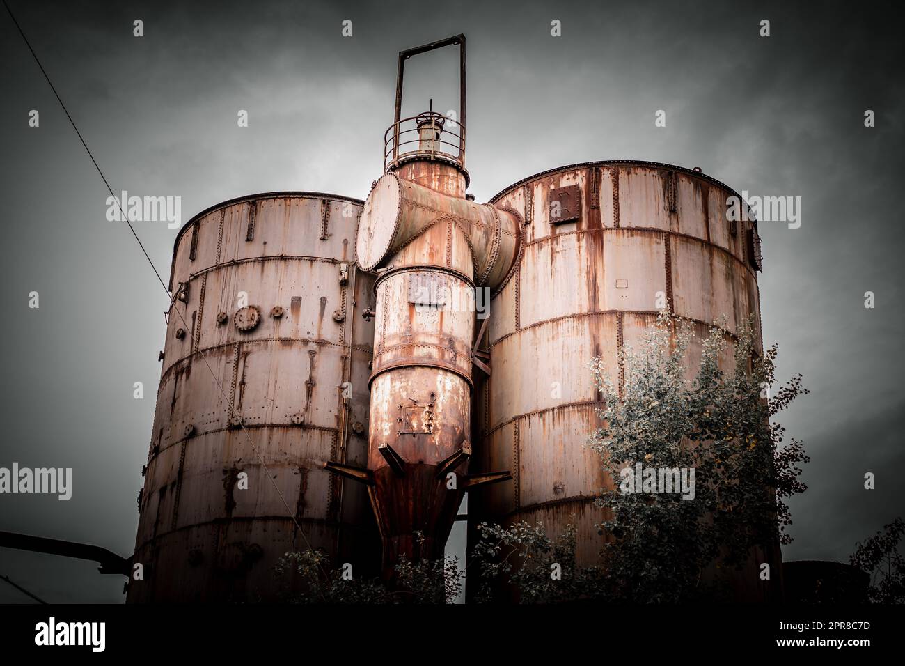 The two rusty industrial tanks of an old factory in Germany Stock Photo ...