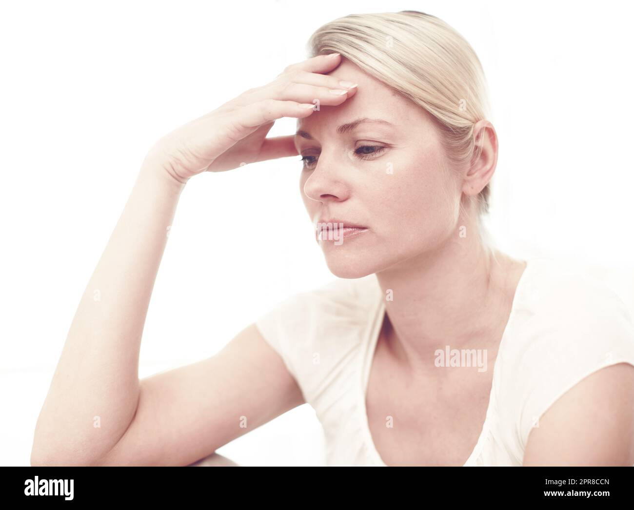 Preoccupied with her problems. A concerned looking blonde woman looking ...