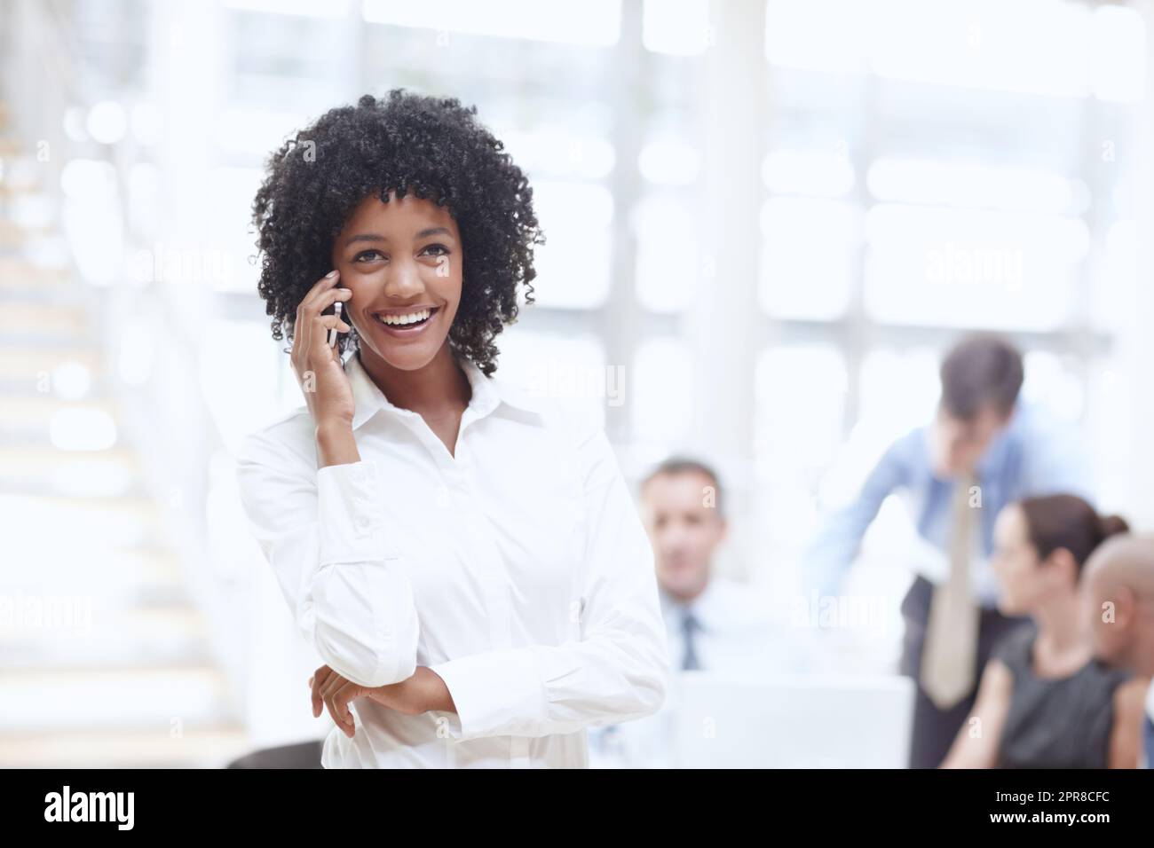 Talking with clients on the phone. An african woman speaking on her ...