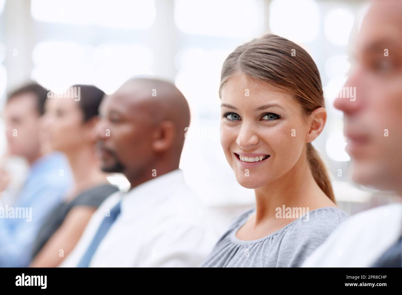 Dedicated young employee. Beautiful business executive smiles at you ...