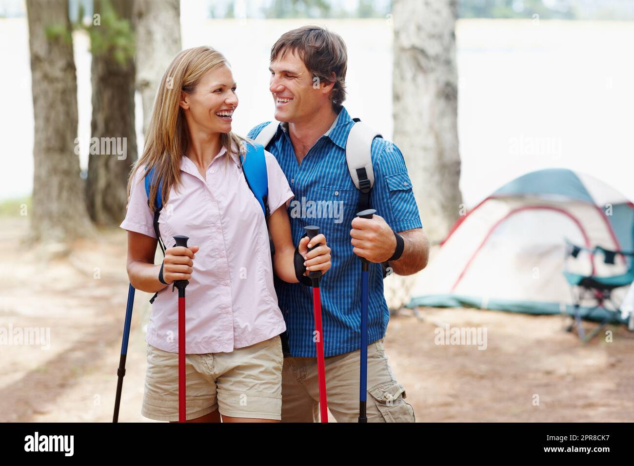 Couple ready for trekking. Happy couple with backpack holding trekking ...