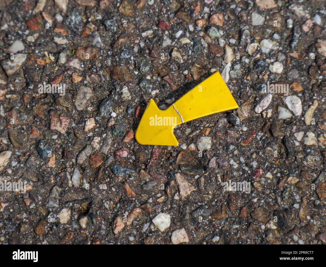 yellow metal arrow on road surface Stock Photo - Alamy