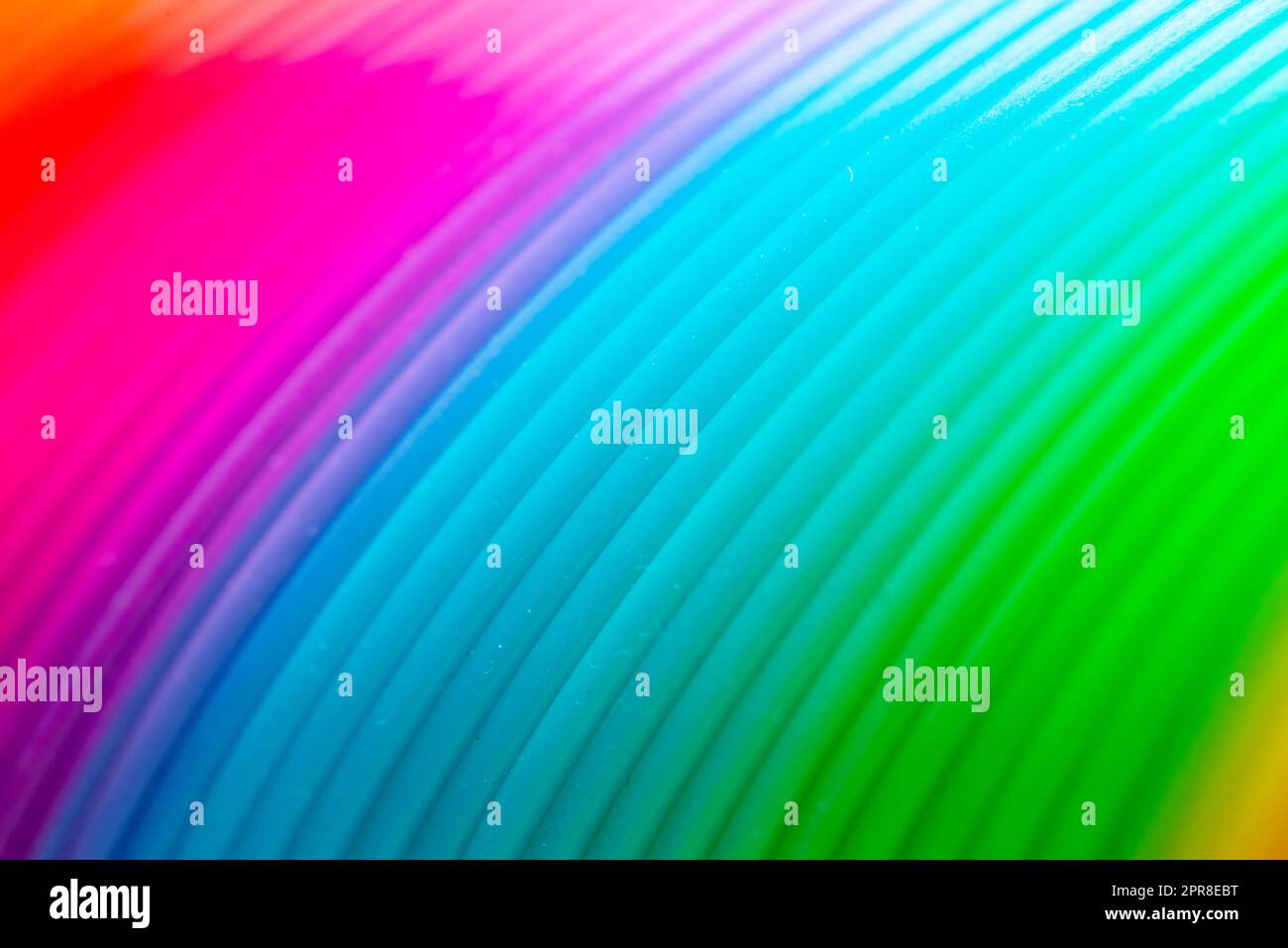 Details of a rainbow coloured plastic toy Stock Photo - Alamy