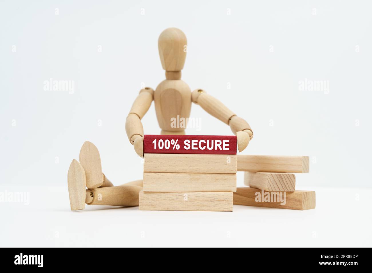 Business concept. On a white surface sits a wooden man in his hands a ...