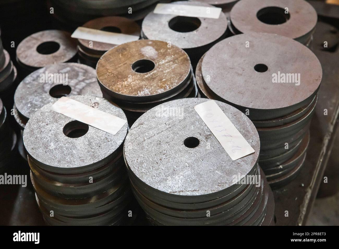 round metal workpieces lie on the cart at factory Stock Photo - Alamy