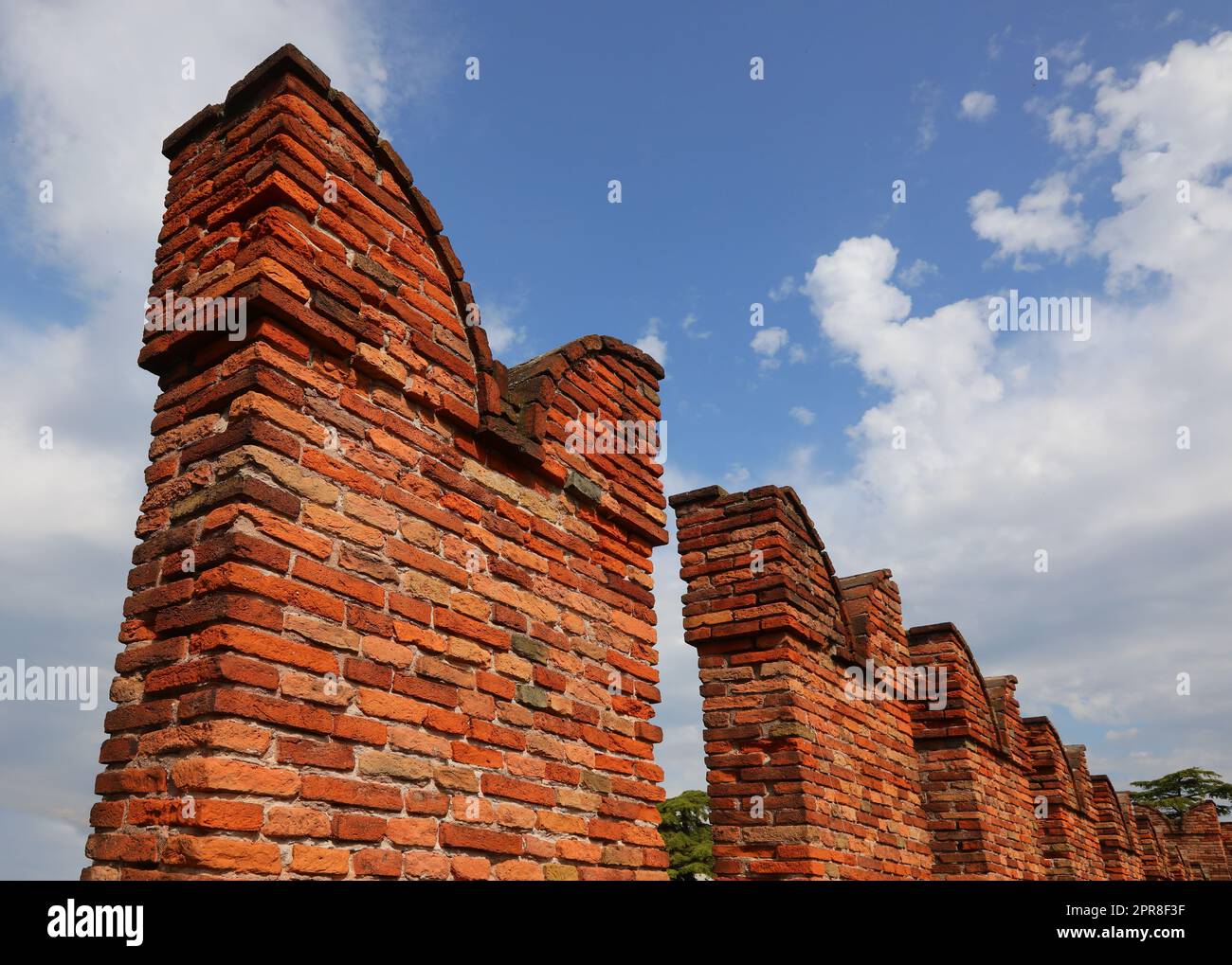 Ancient Battlements with crenellations on the city wall made with red ...