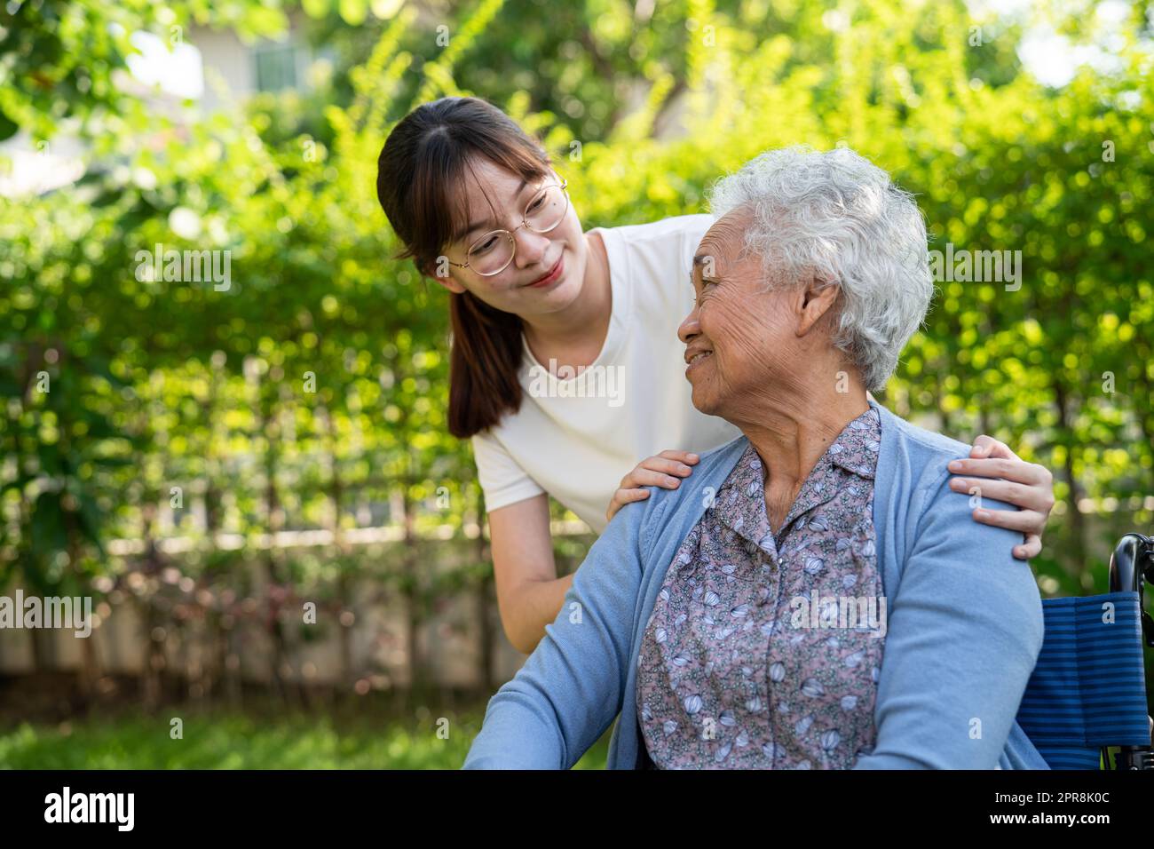 Caregiver help and care Asian senior or elderly old lady woman patient sitting and happy on ...