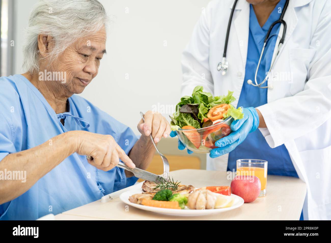 Asian senior or elderly old lady woman patient eating breakfast and ...