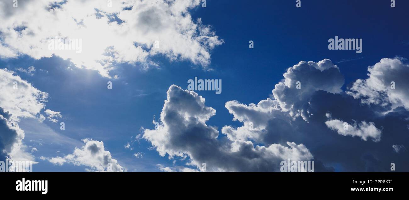 Blue sky with clouds and sun shines bright in the daytime in summer ...