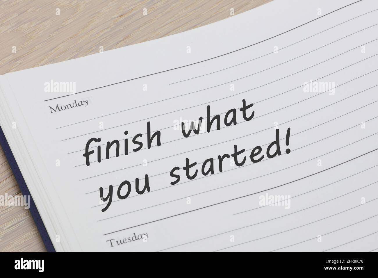 Finish what you started diary reminder appointment open on desk Stock ...