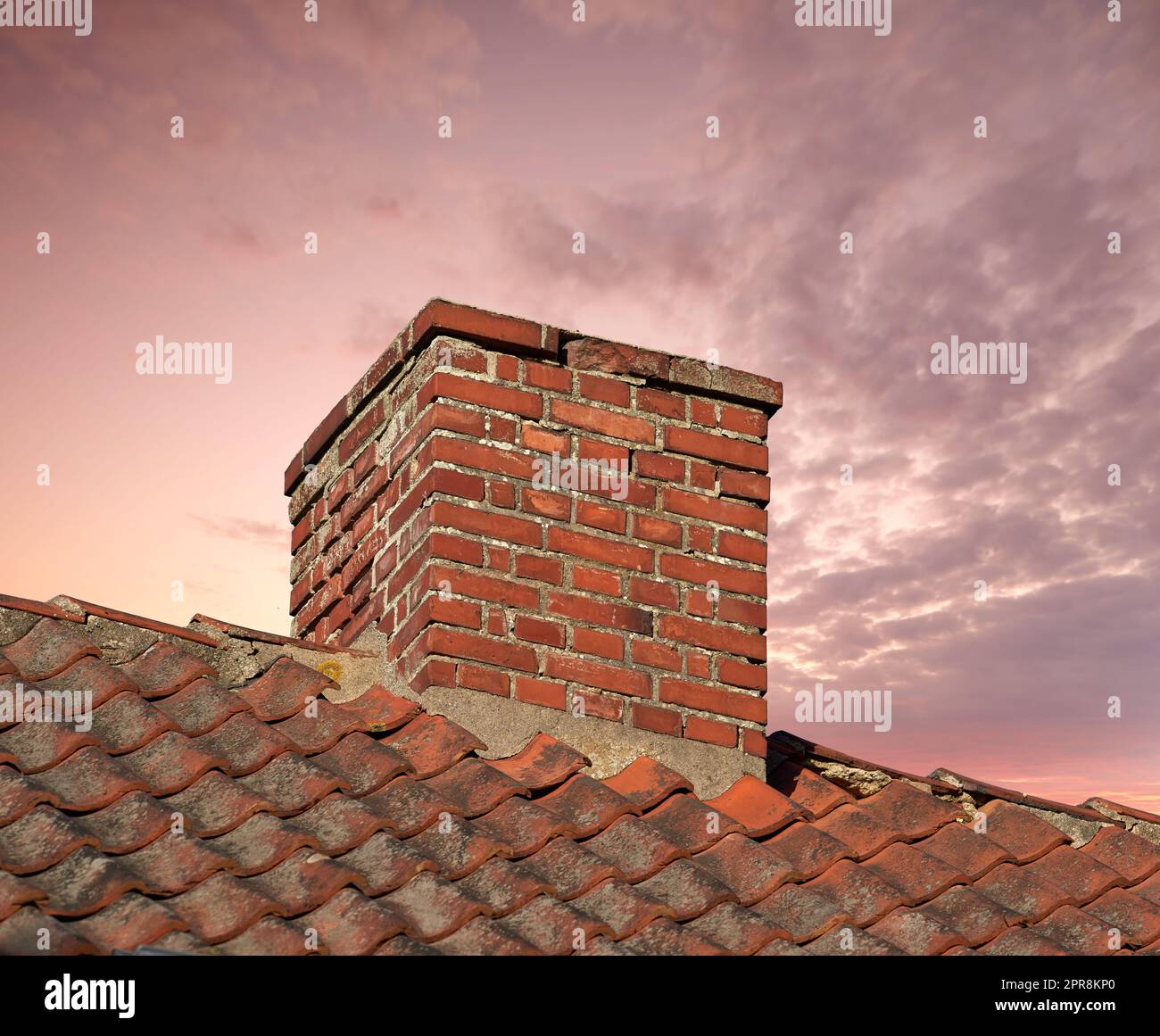 Closeup of a chimney on an old red brick house with copy space sky ...