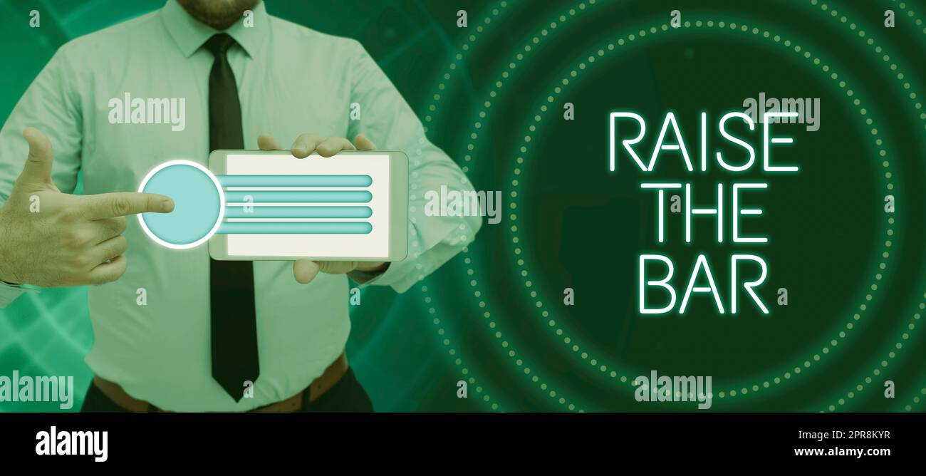 Sign displaying Raise The Bar. Word Written on Set higher standards ...