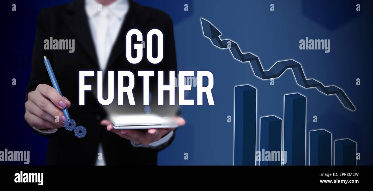 Sign displaying Go Further. Word Written on To move to a greater ...