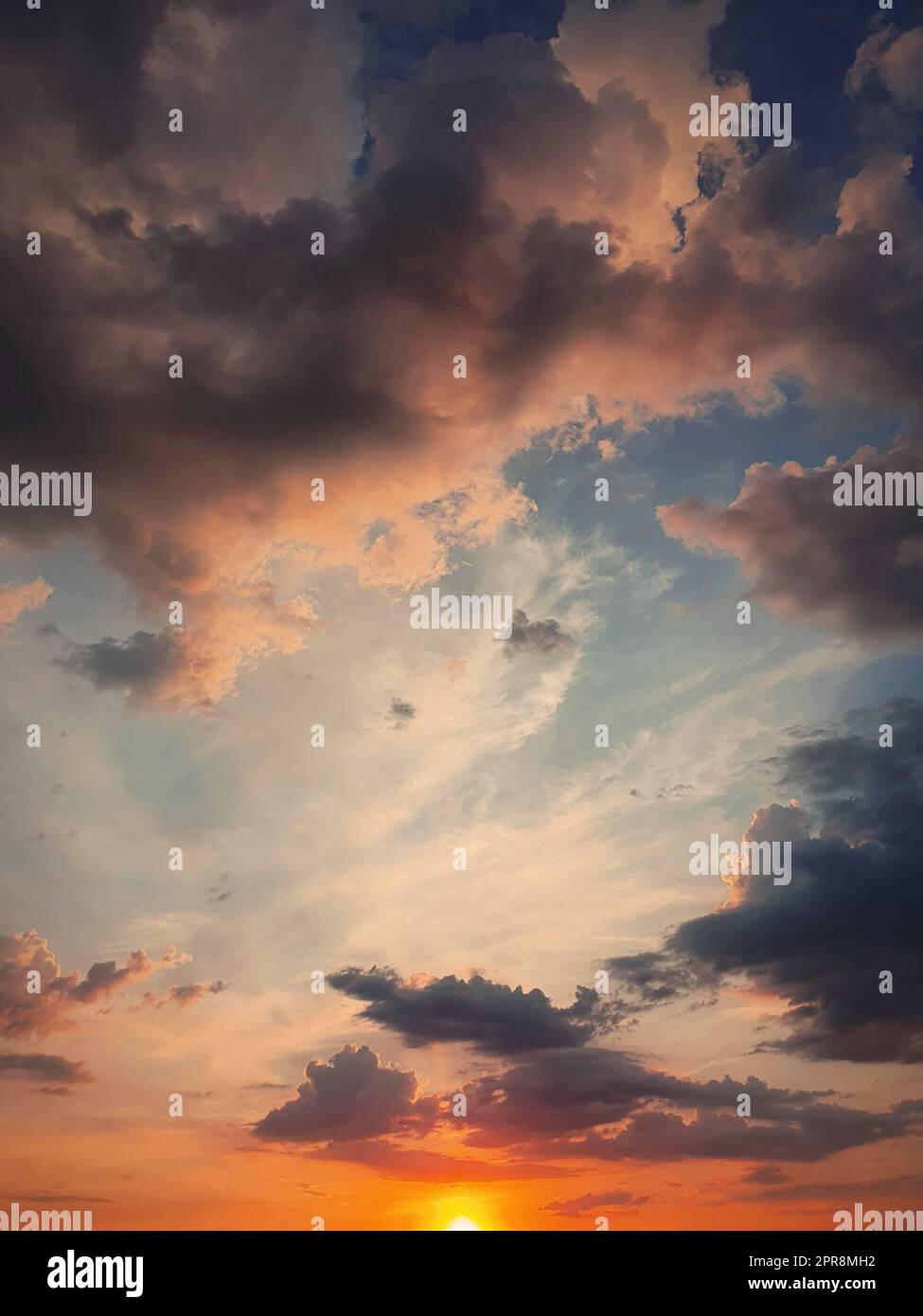 Wonderful colored sunset sky with tiny sun over the horizon, vertical ...