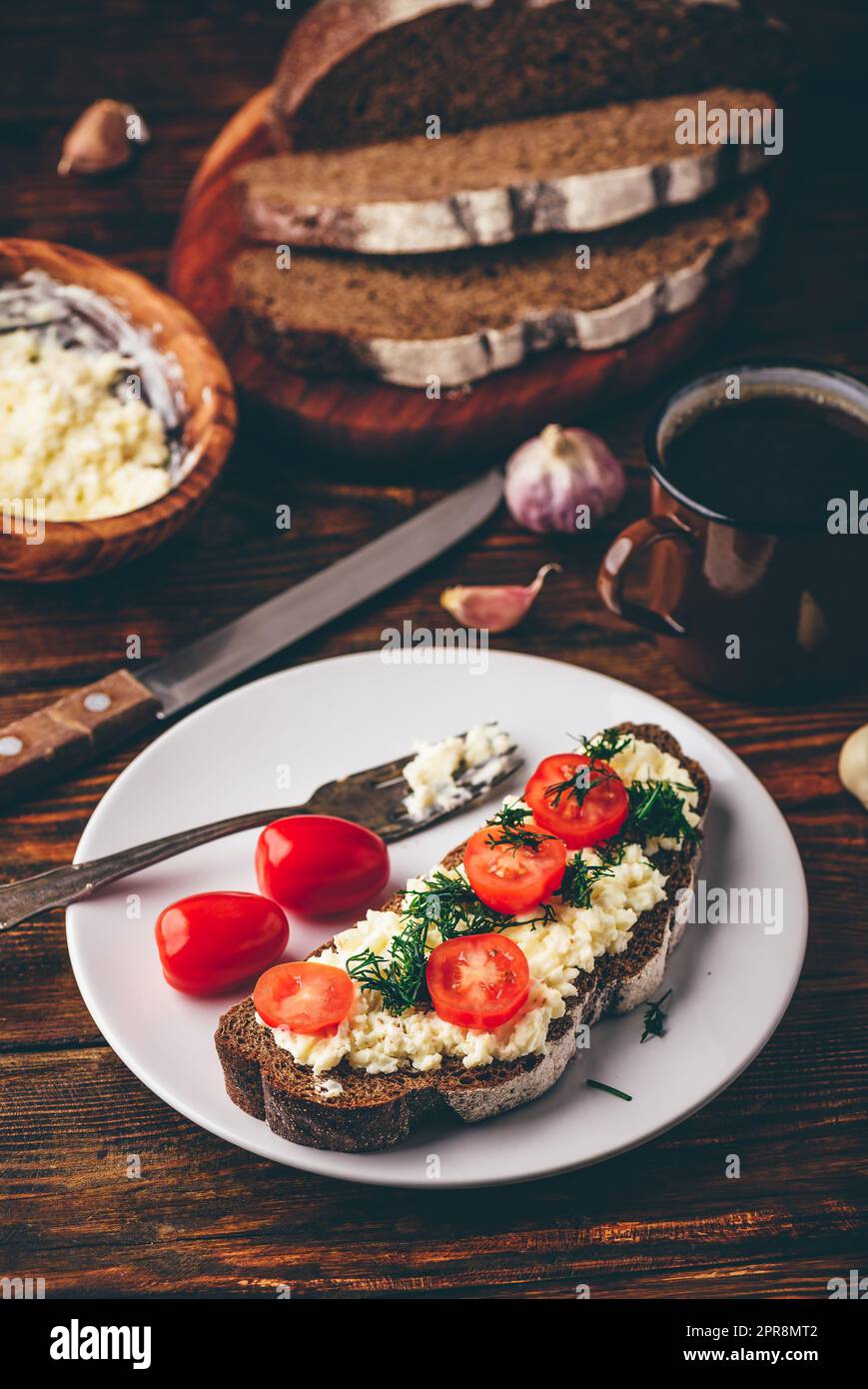 Rye bread toast with processed cheese, garlic and tomatoes Stock Photo ...