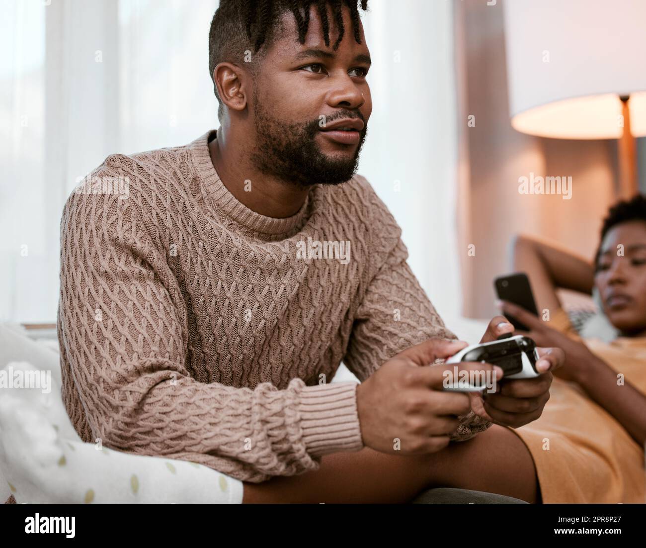 Gaming allows you live more than one life. a handsome young man playing ...