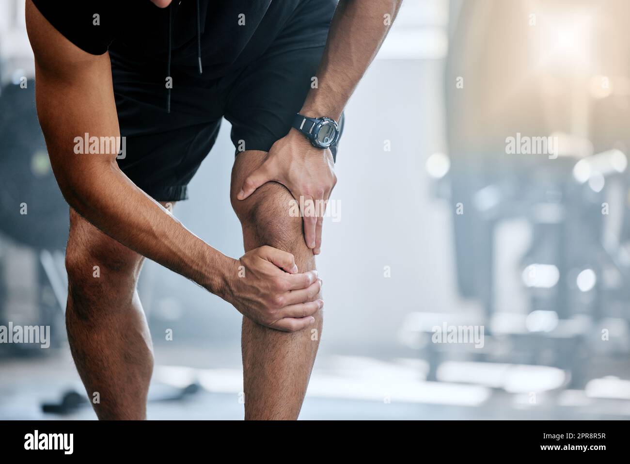 Unknown trainer alone in gym and suffering from knee injury. One coach ...