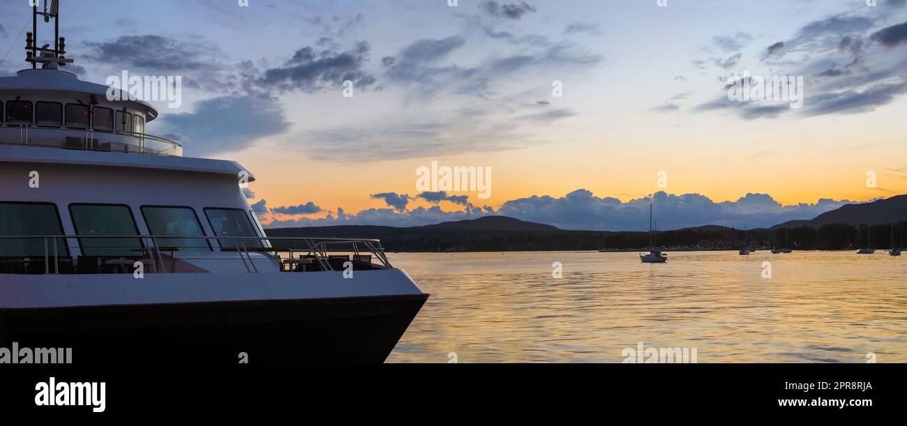 Memphremagog lake orange sunset panoramic landscape with boats at Magog ...