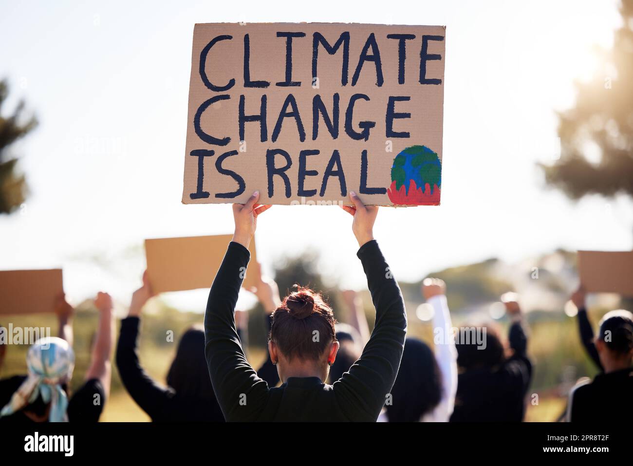 Every planet will be aligned. a group of people protesting climate ...