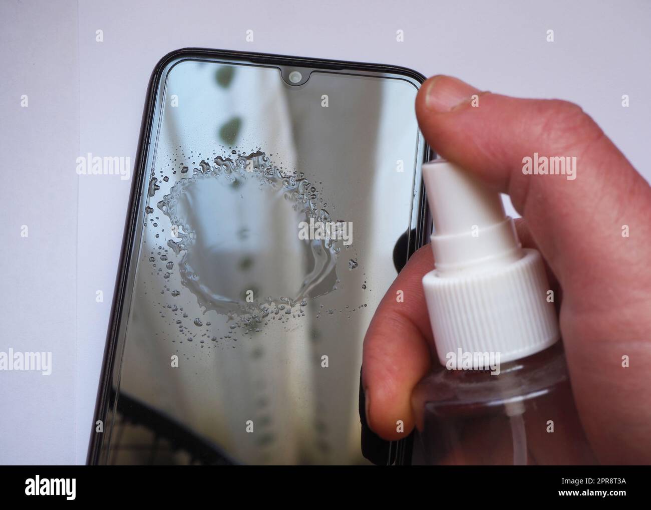 Cleaning fluid sprayed onto the screen. Smart device surface ...