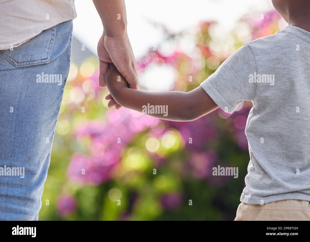Closeup Father And Son Holding Hands While Walking Outside In The