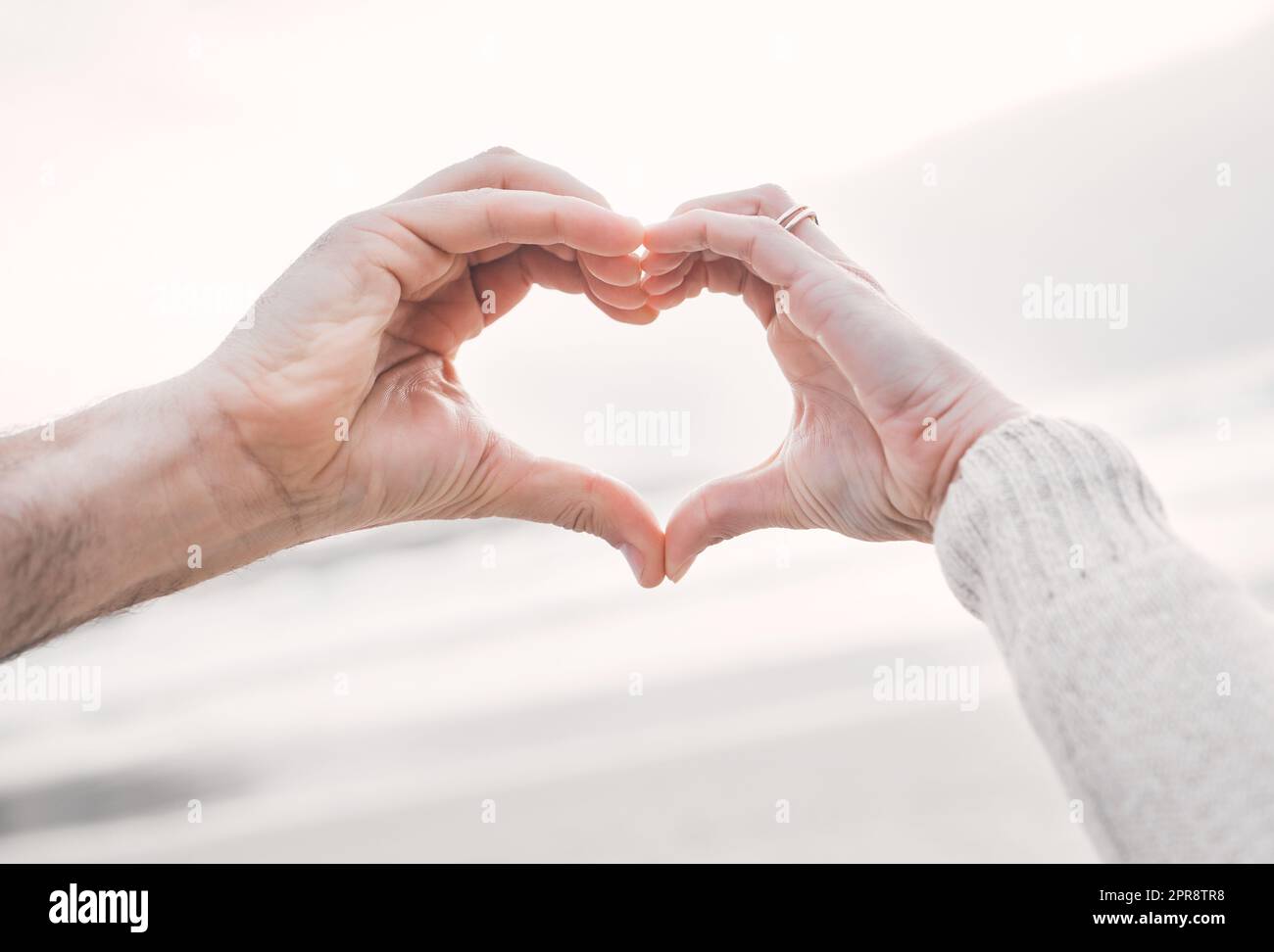 Two People Making A Heart With Their Hands