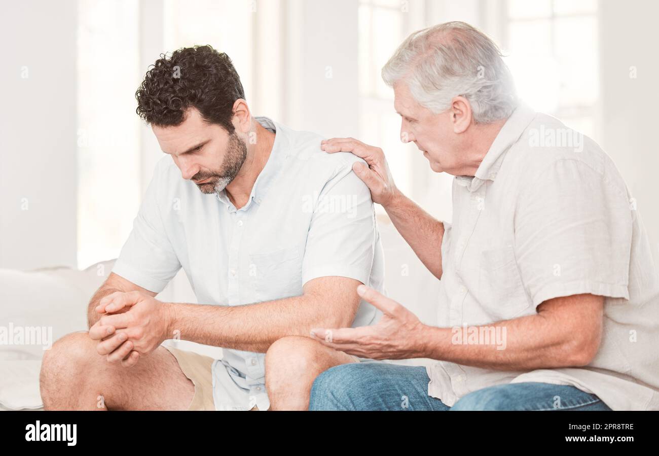 Ill help you through this. a father consoling his son at home Stock ...