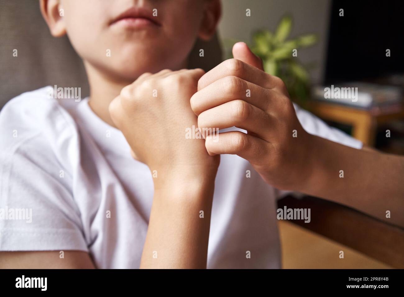 Child practicing EFT or emotional freedom technique - tapping on the side of the hand point ...