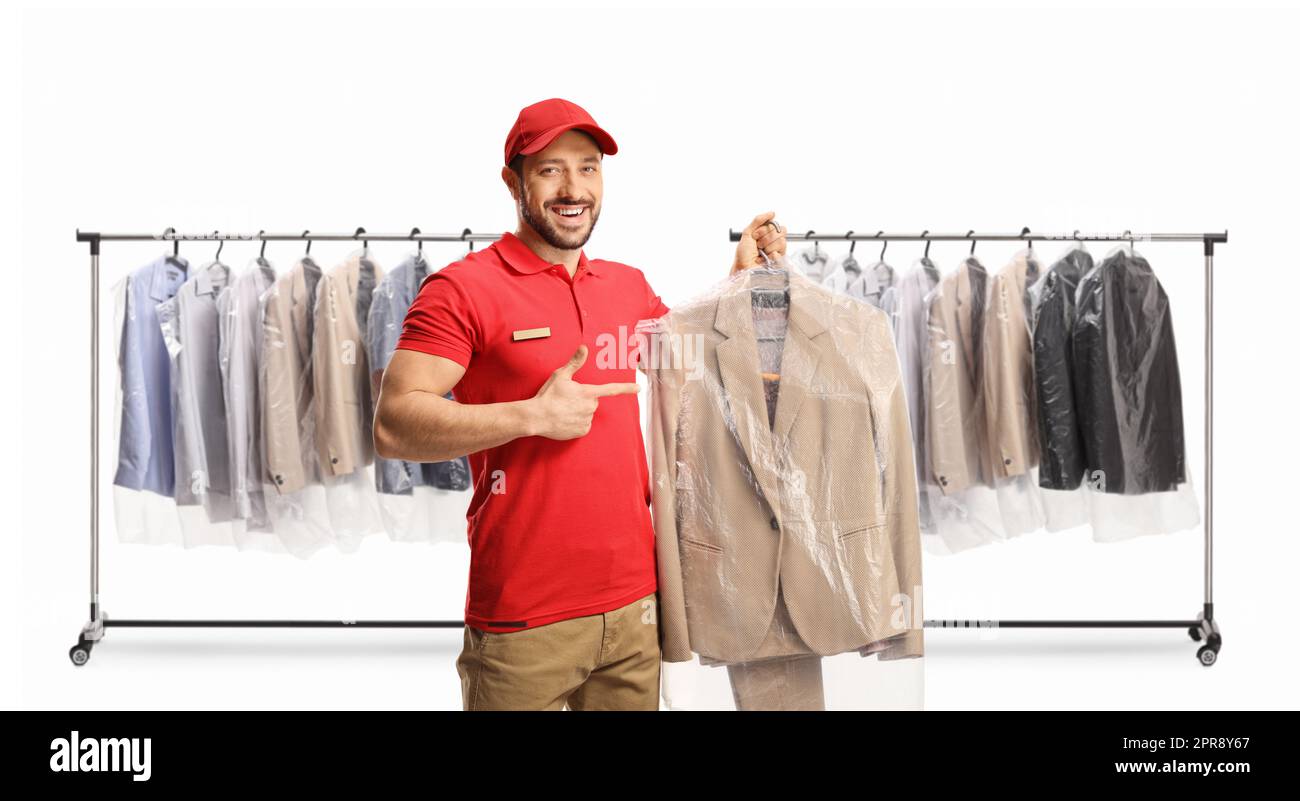 Clothing racks and a dry cleaning worker holding a suit on a hanger ...