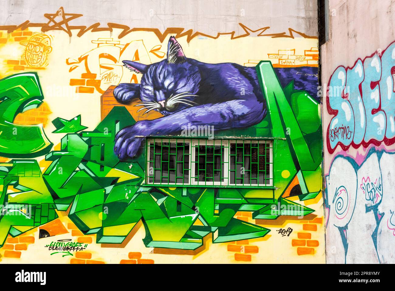 Sleeping black cat graffiti urban street art on wall in Sofia, Bulgaria ...