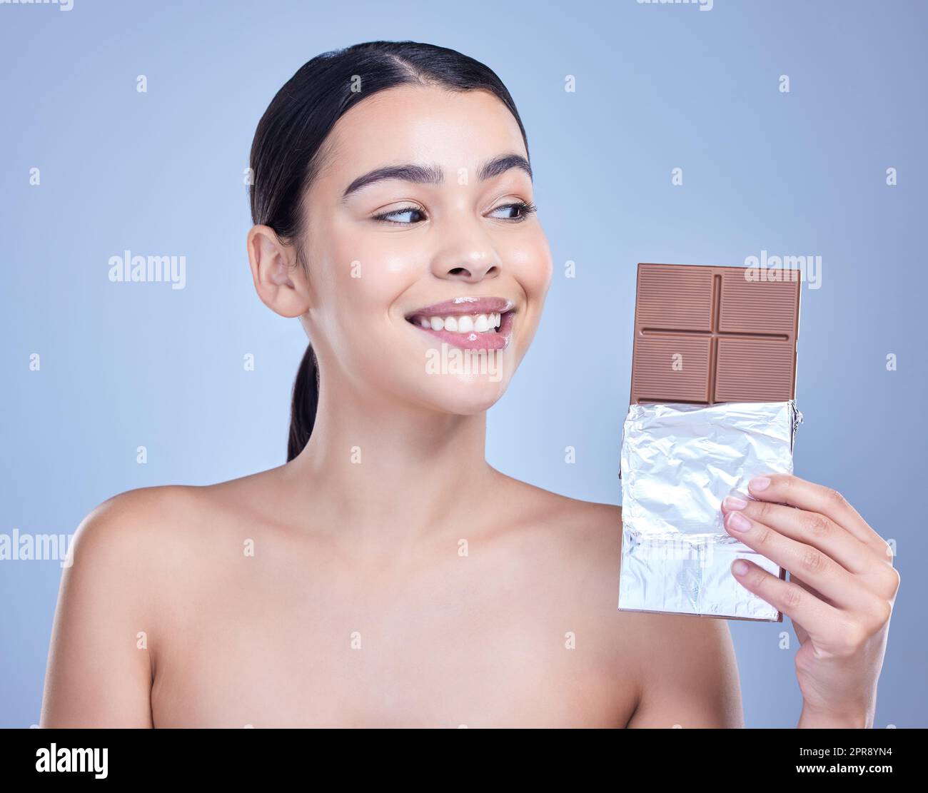 A beautiful mixed race woman holding a slab of chocolate. Hispanic ...