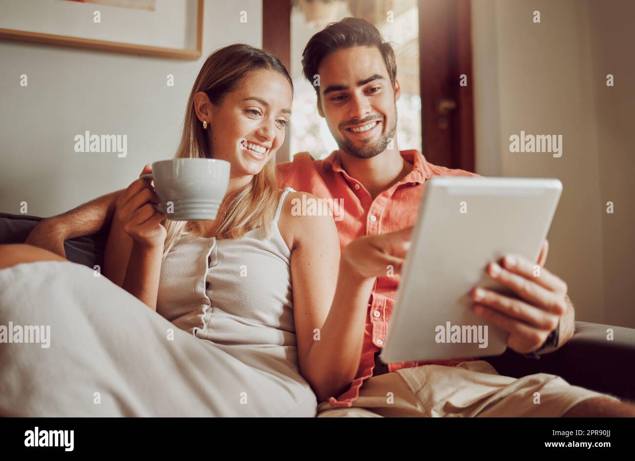 Lets look at that. a young couple using a digital tablet together at ...