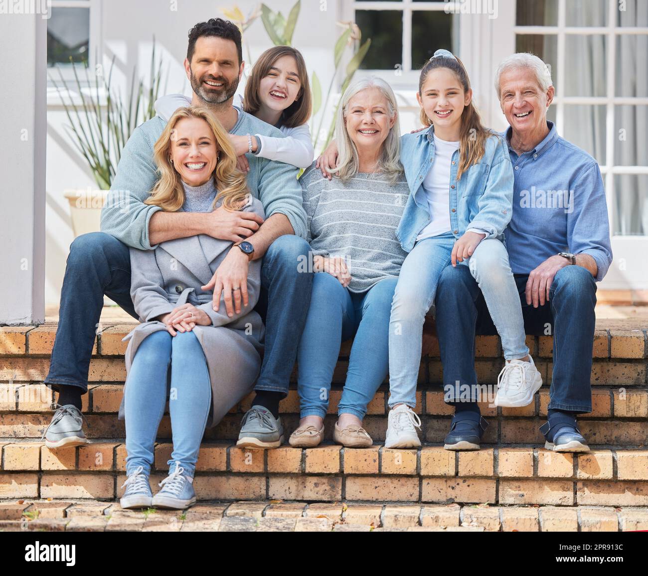 We love our time together. Full length shot of a family sitting outside ...