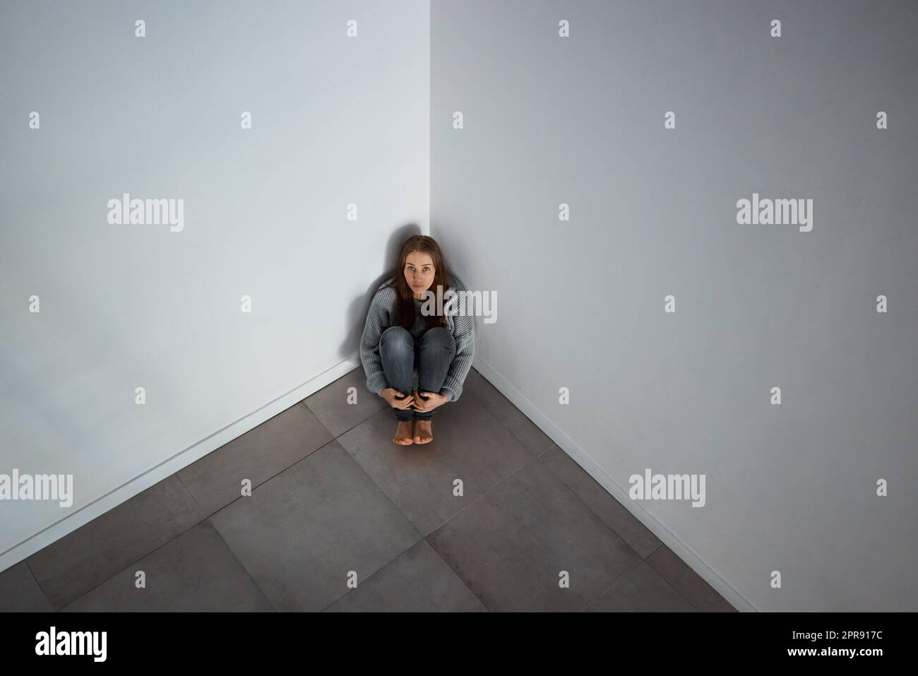 Young woman sad corner hi-res stock photography and images - Alamy