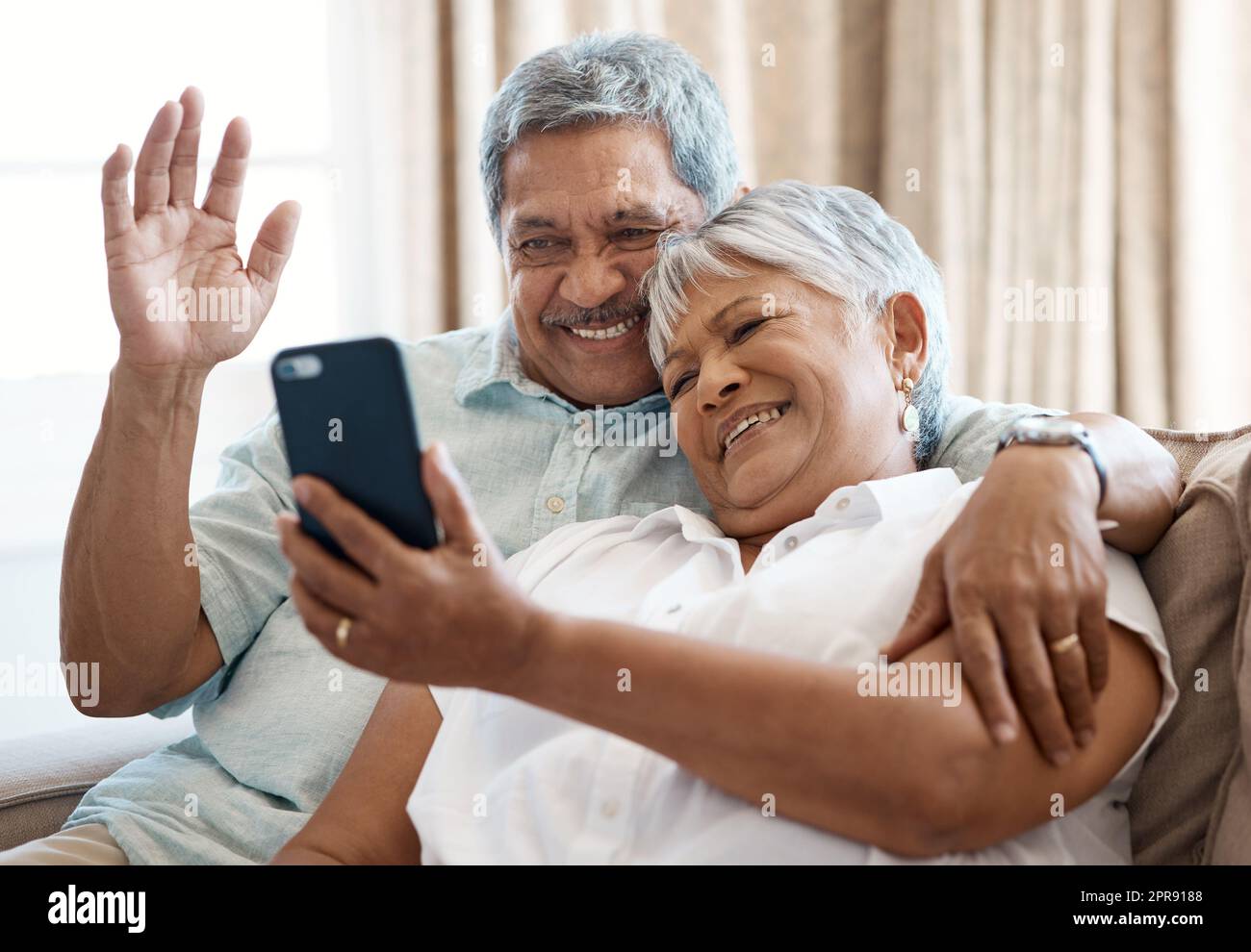 Reaching out to those far away. a senior couple on a call together at ...