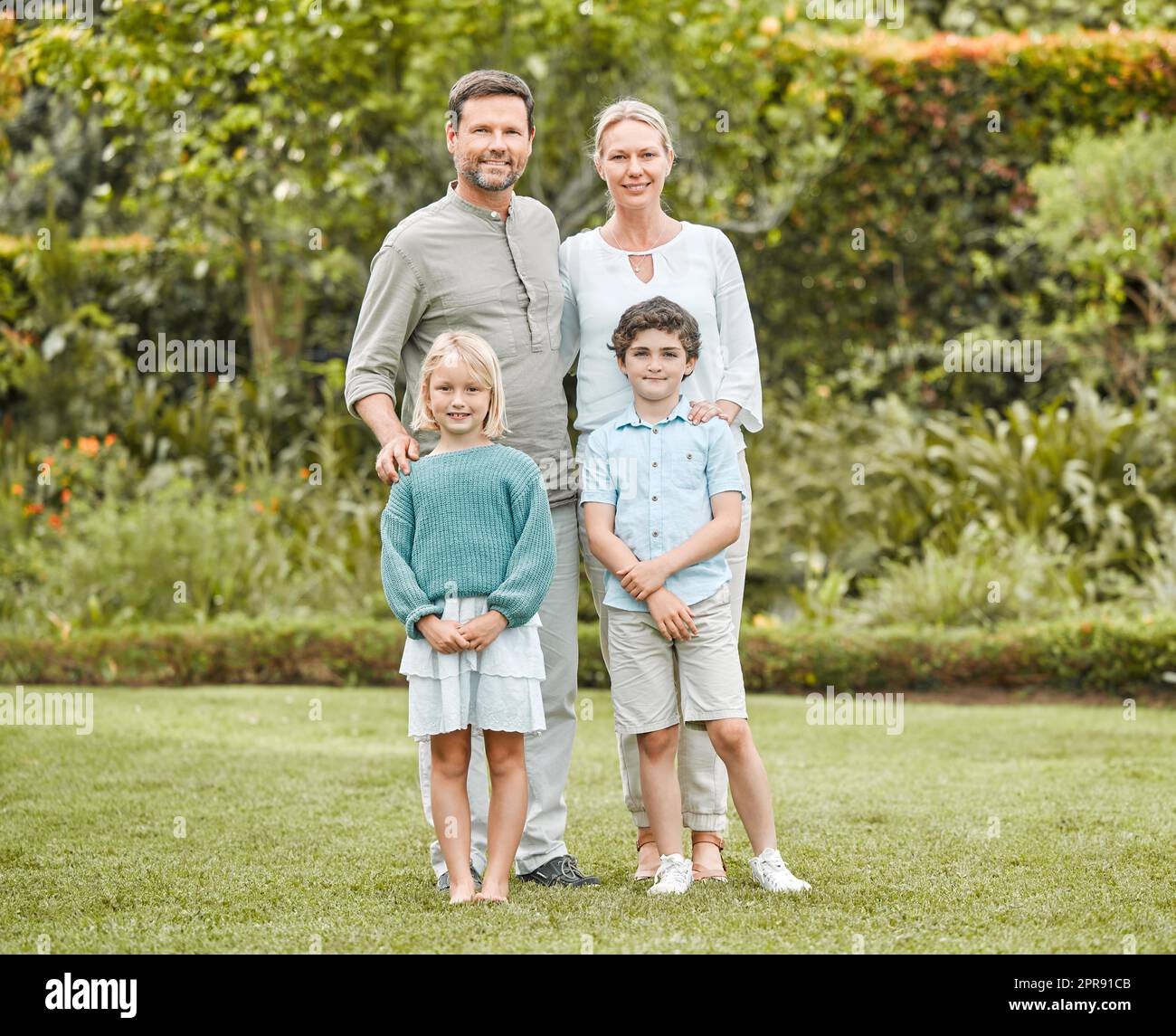 Four hearts that beat as one. a couple standing outside with their two ...
