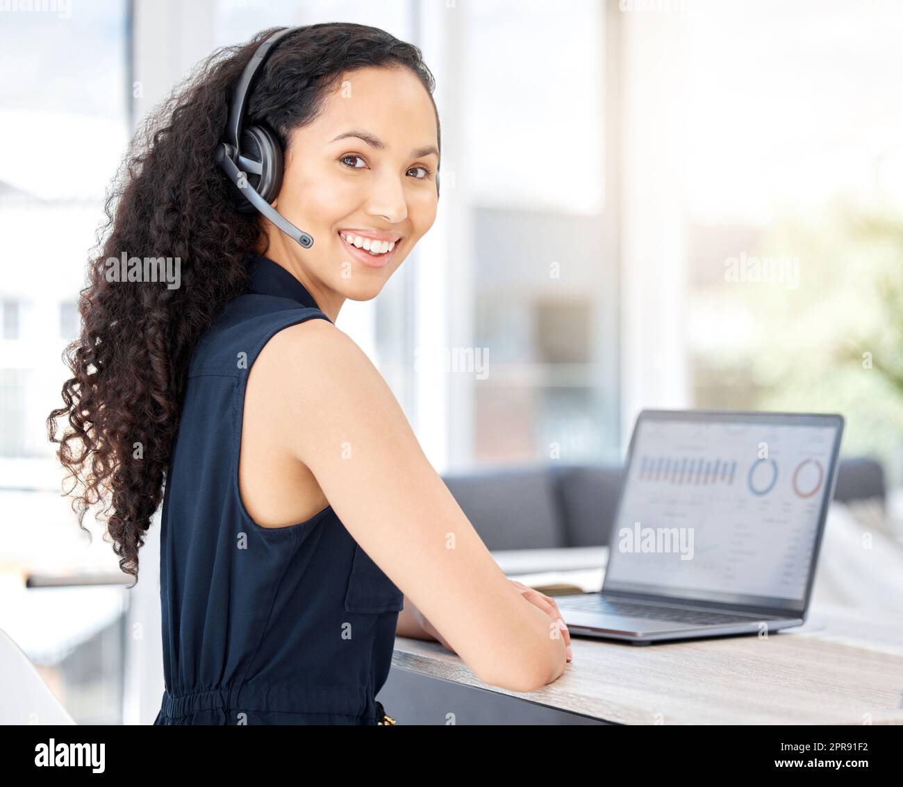 Just started work. a young female call center agent at work Stock Photo ...