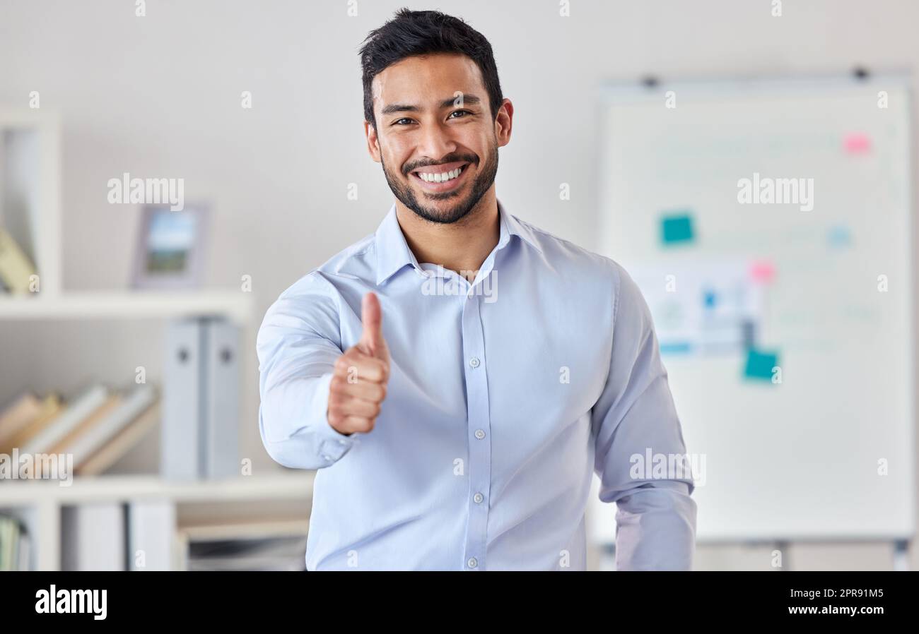 Young happy handsome mixed race businessman showing a thumbs up ...